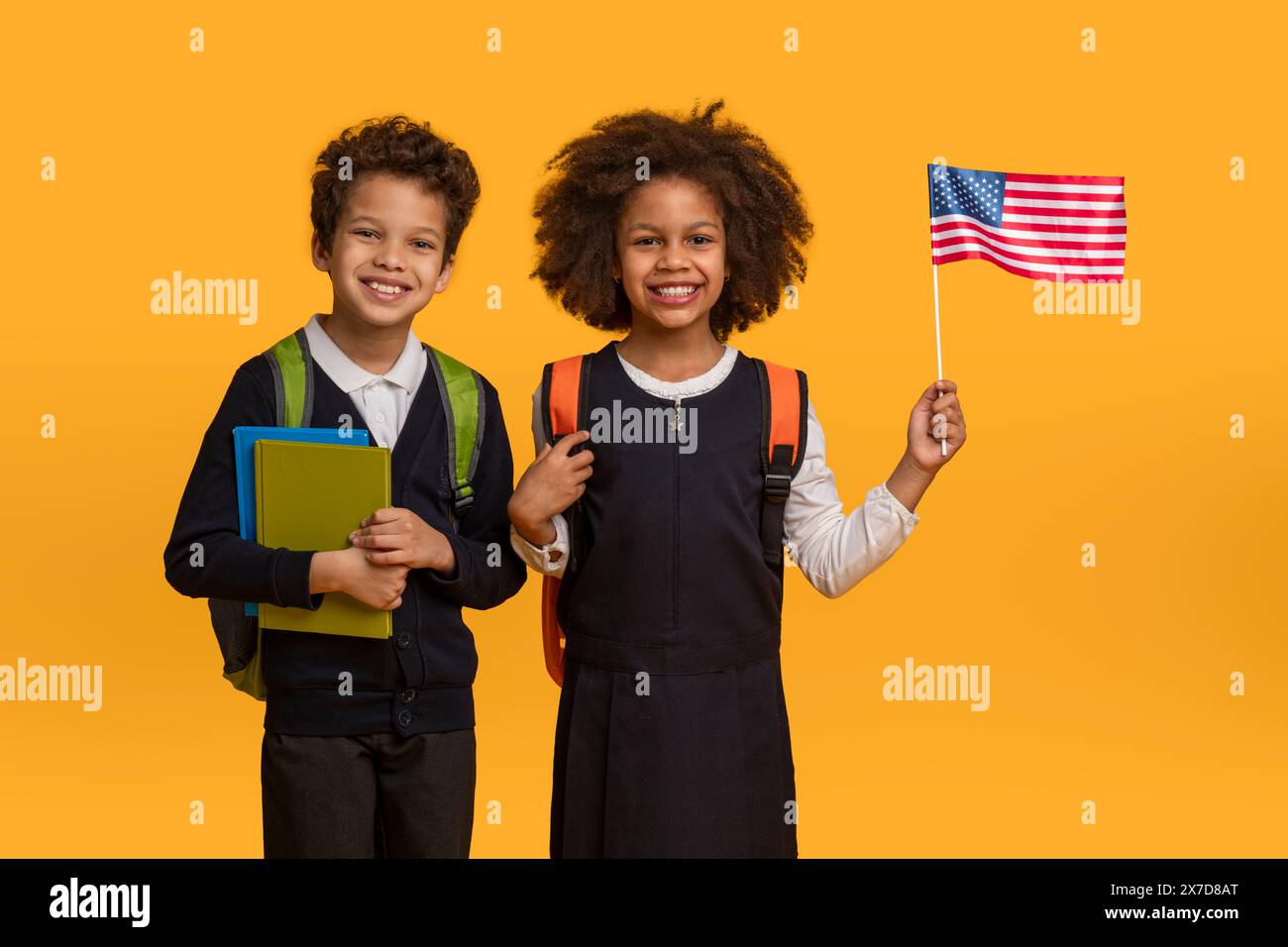 Smiling Brother and Sister Holding School Supplies and American Flag ...