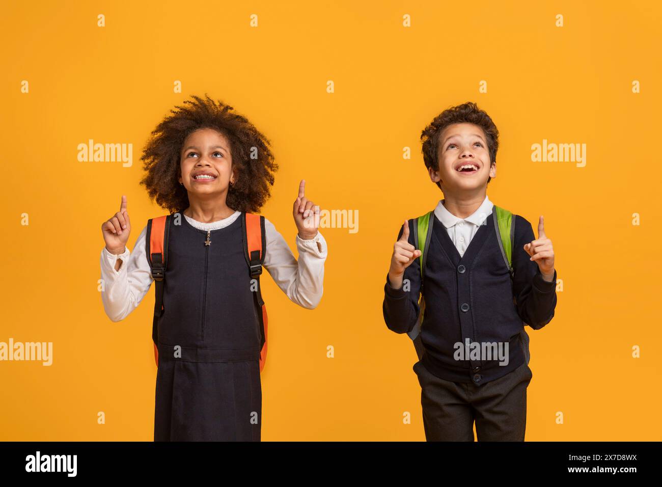 Two Children in School Uniforms Pointing Above Stock Photo - Alamy