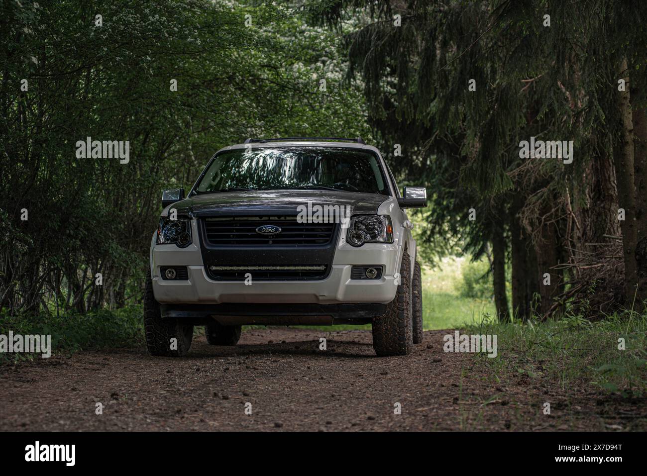 Ford Explorer truck in villige road with more trees Stock Photo - Alamy