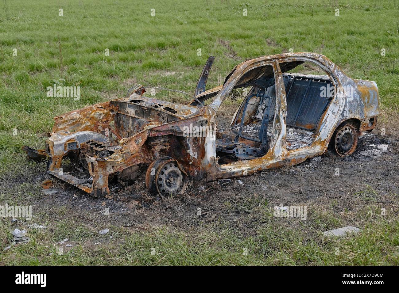 Burned down car in the field. Full destroyed vehicle. Protests and ...