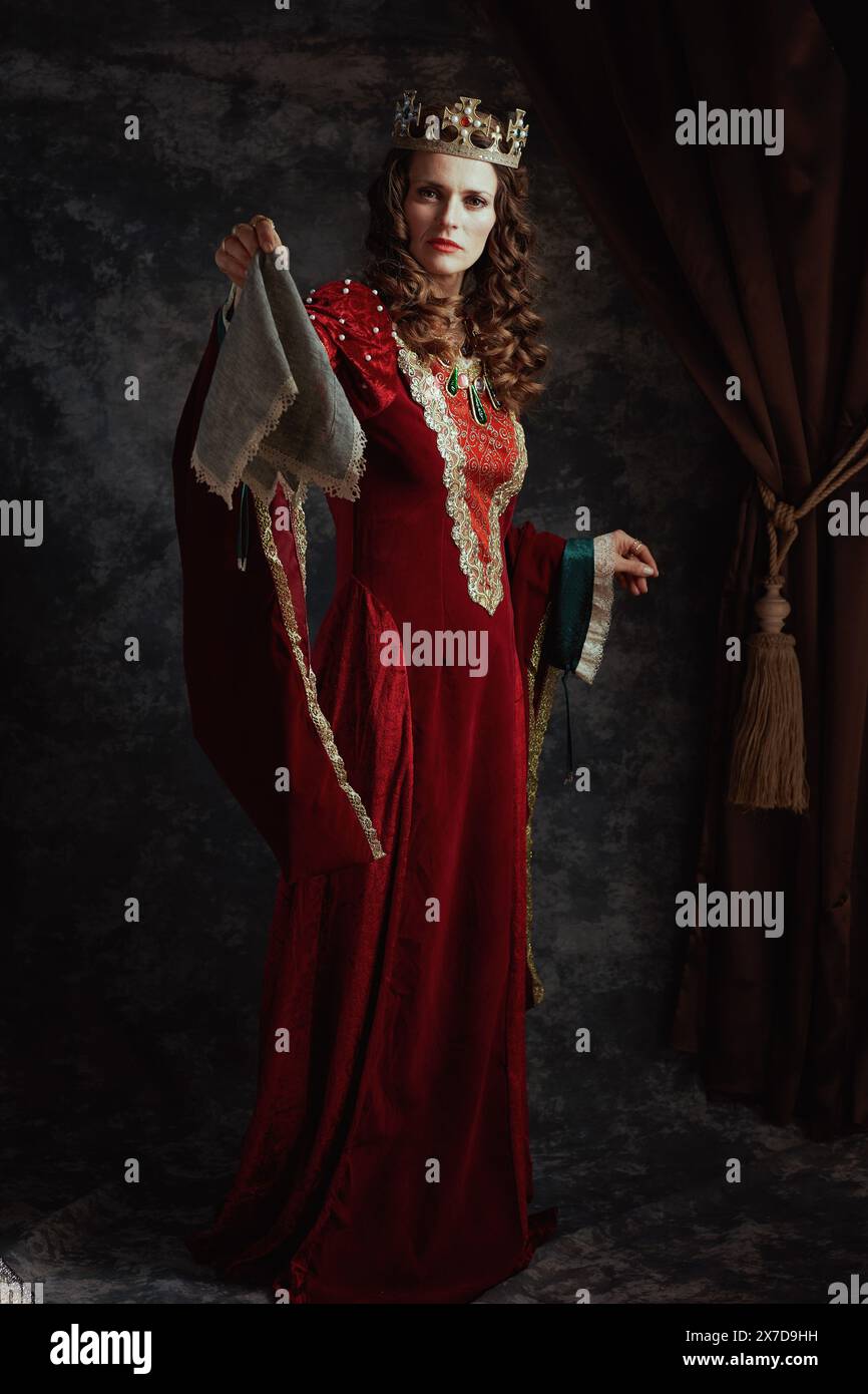 Full length portrait of medieval queen in red dress with handkerchief ...