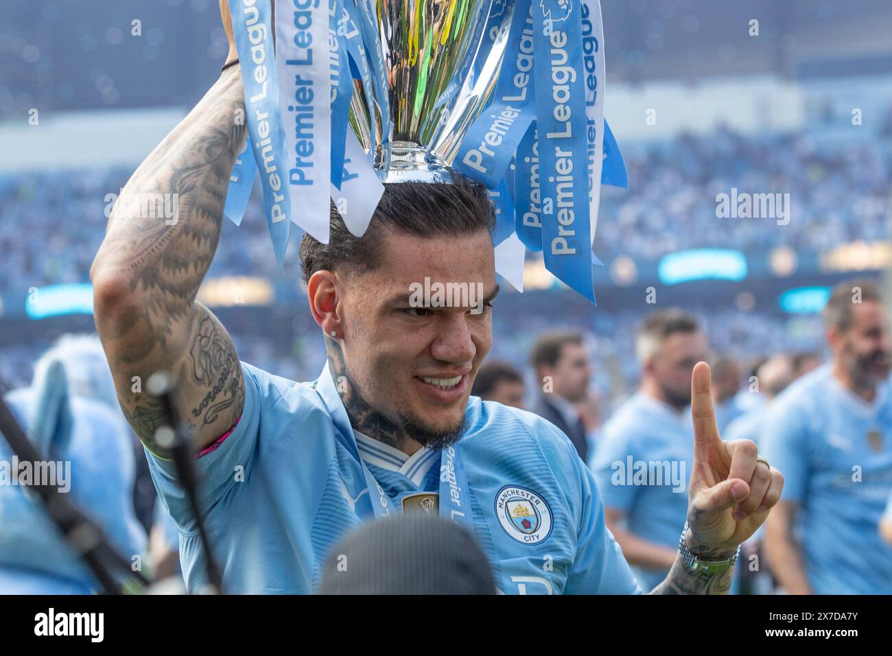 Ederson of Manchester City lifts the Premier League Trophy during the ...