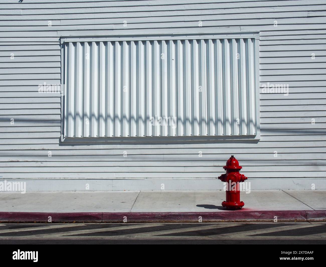 Red fire hydrant and white hurricane shutters, art photo, USA, April 17 ...