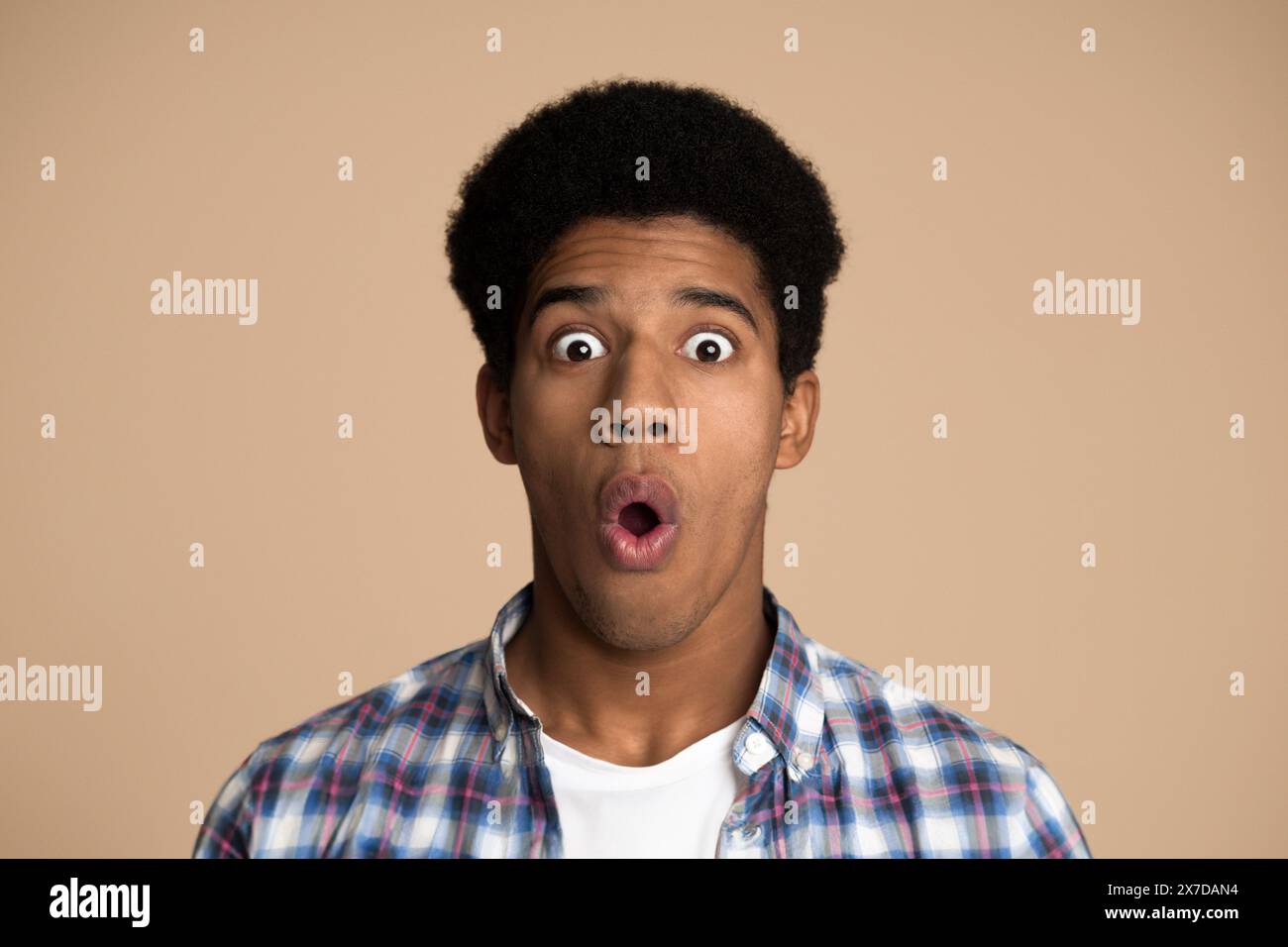 Omg. Shocked guy looking at camera over studio background Stock Photo ...