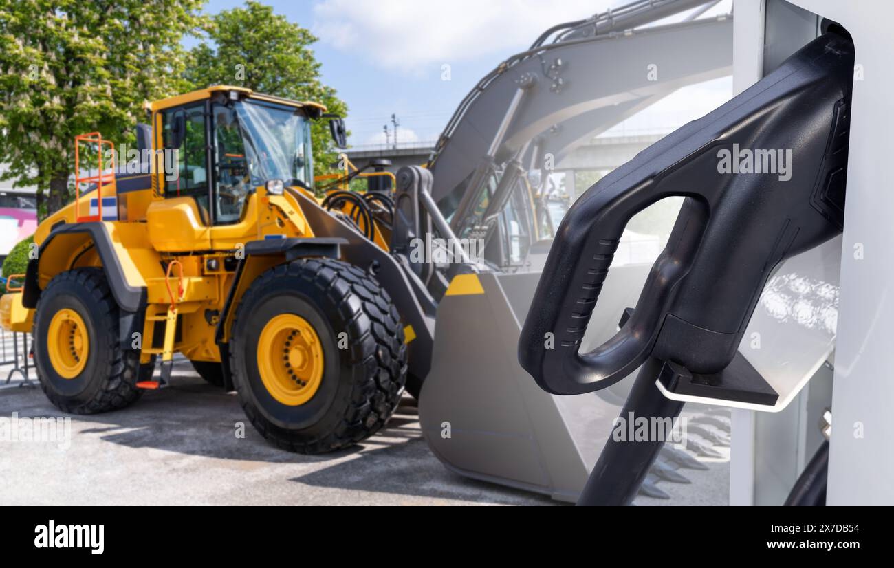 Electric construction machines with charging station. Concept Stock ...