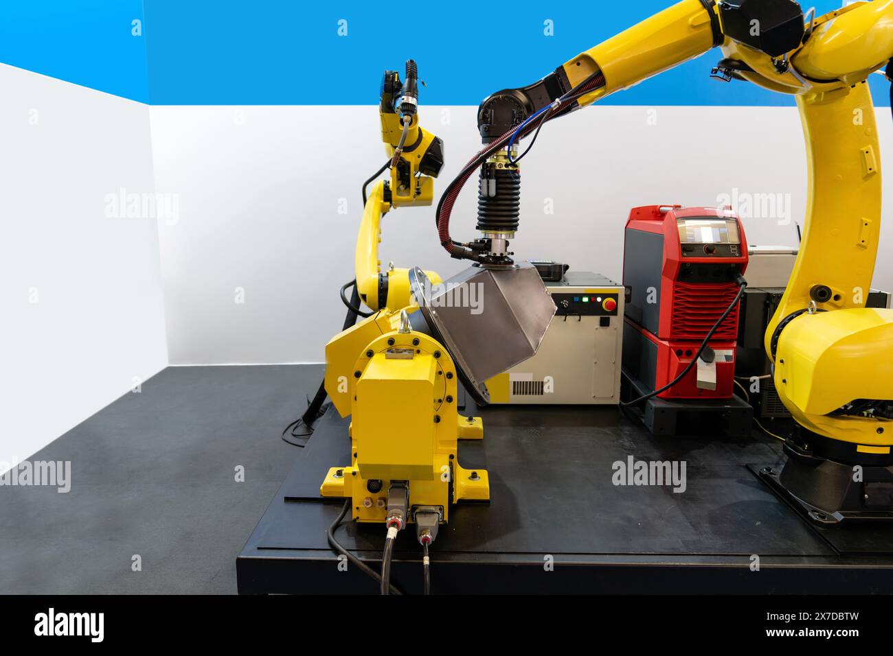 Welding robot arms on a smart factory Stock Photo - Alamy