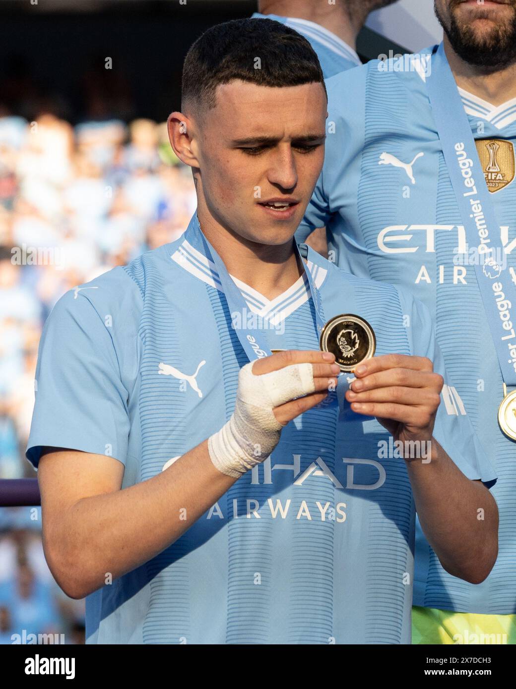 Phil Foden of Manchester City inspects his winner’s medal during the ...