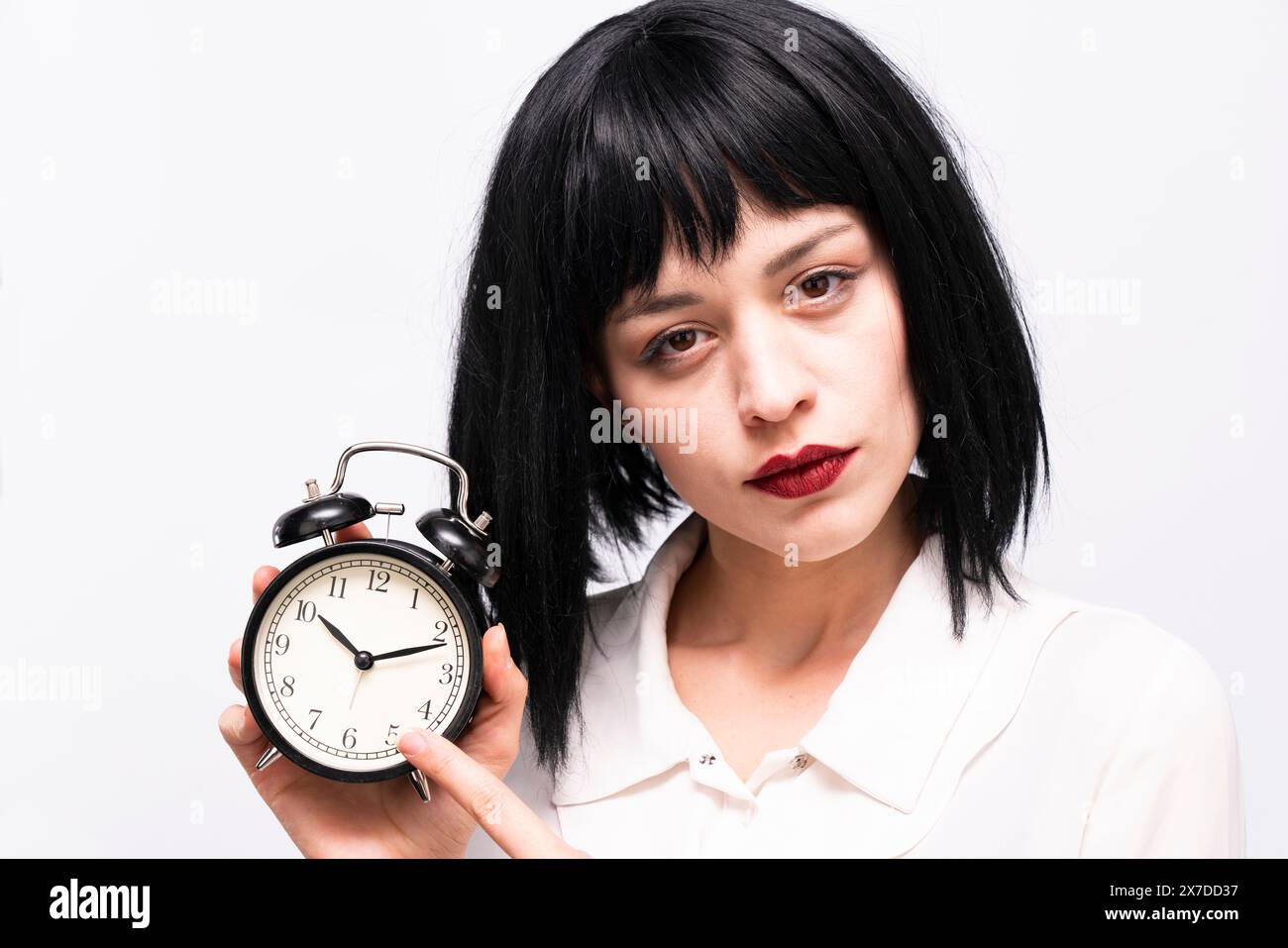 A business woman holding an alarm clock Stock Photo - Alamy
