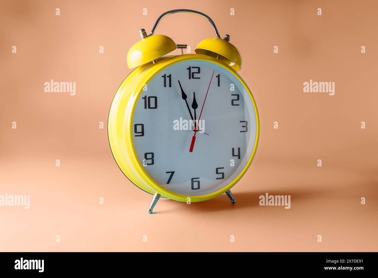Retro style alarm clock on Peach Fuzz color background - trendy color ...