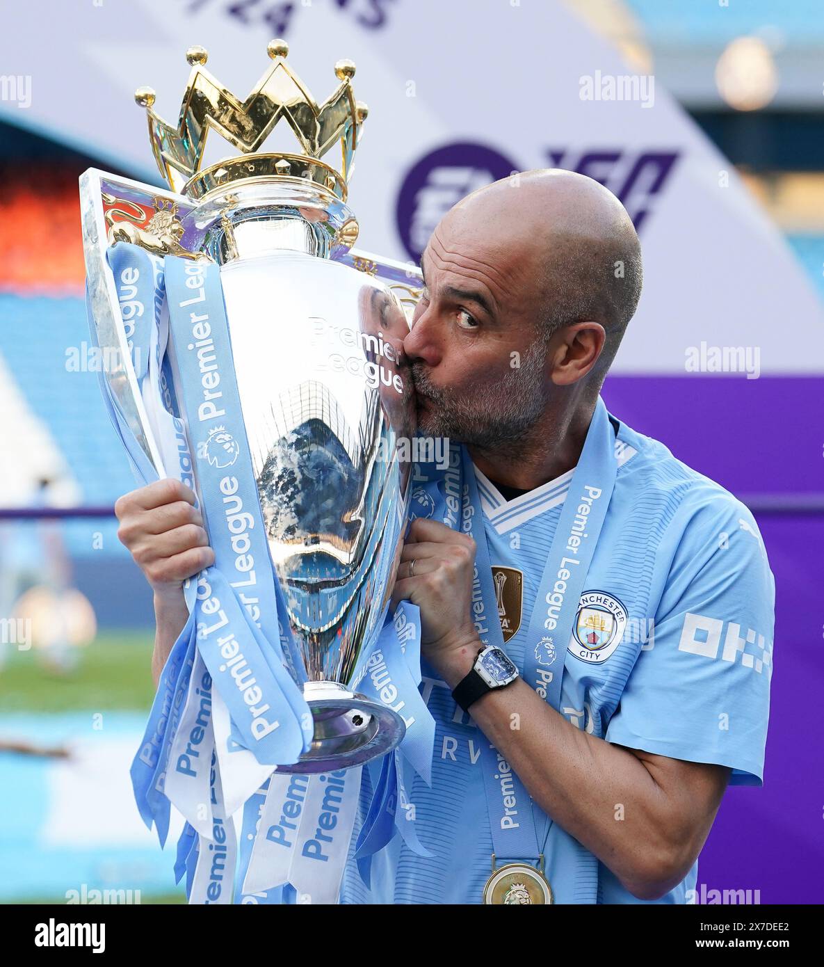 Manchester City manager Pep Guardiola kisses the Premier League trophy ...