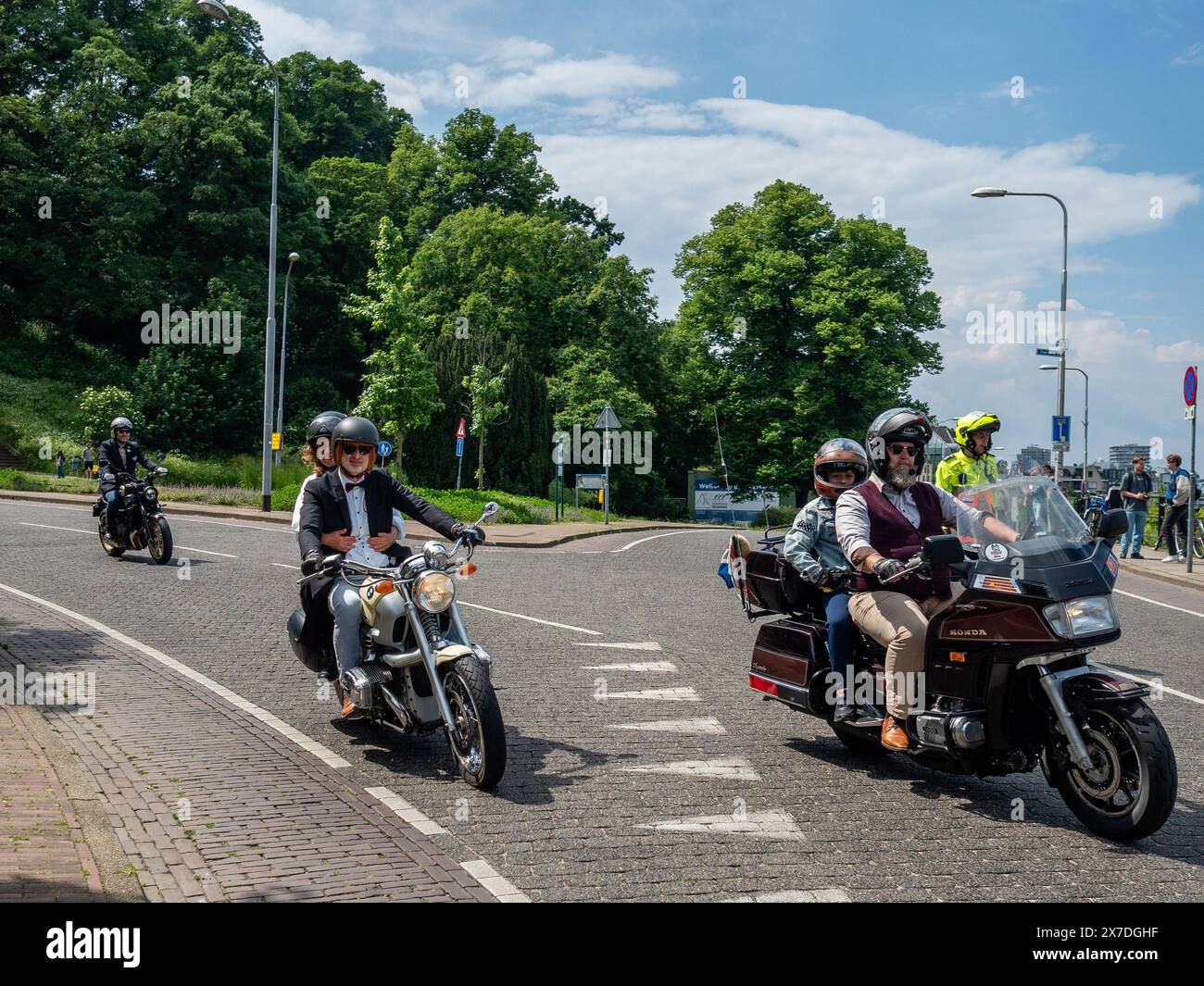 Some men are seen wearing bow ties while riding motorbikes. The ...