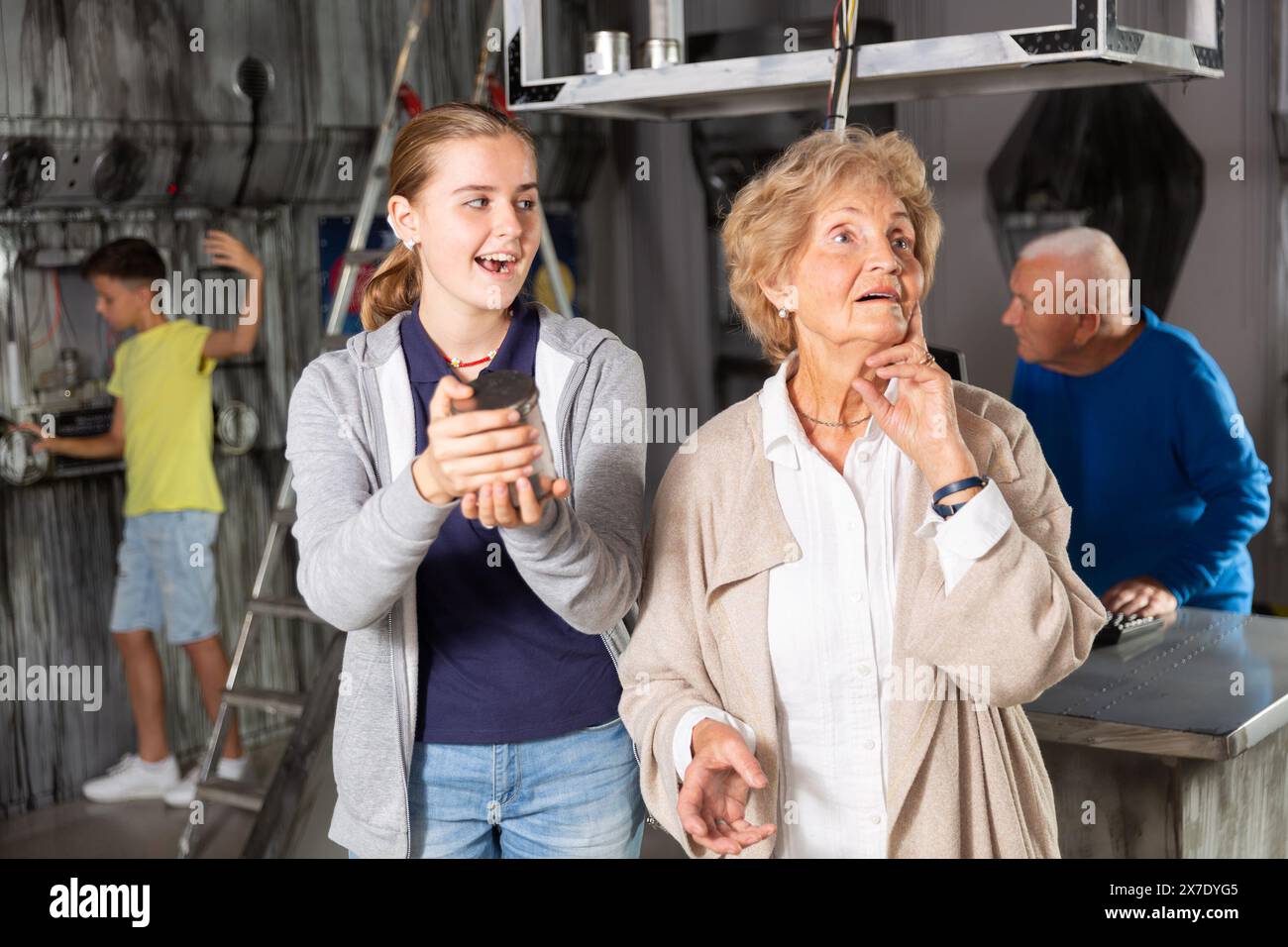 Kids and grandparents solving conundrum in quest room Stock Photo - Alamy