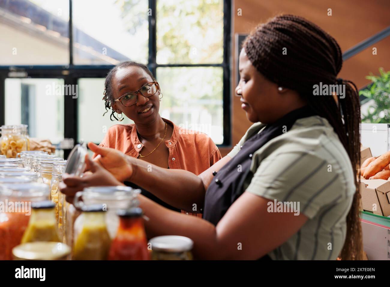 Storeowner explaining health benefits of sustainable organic product to ...