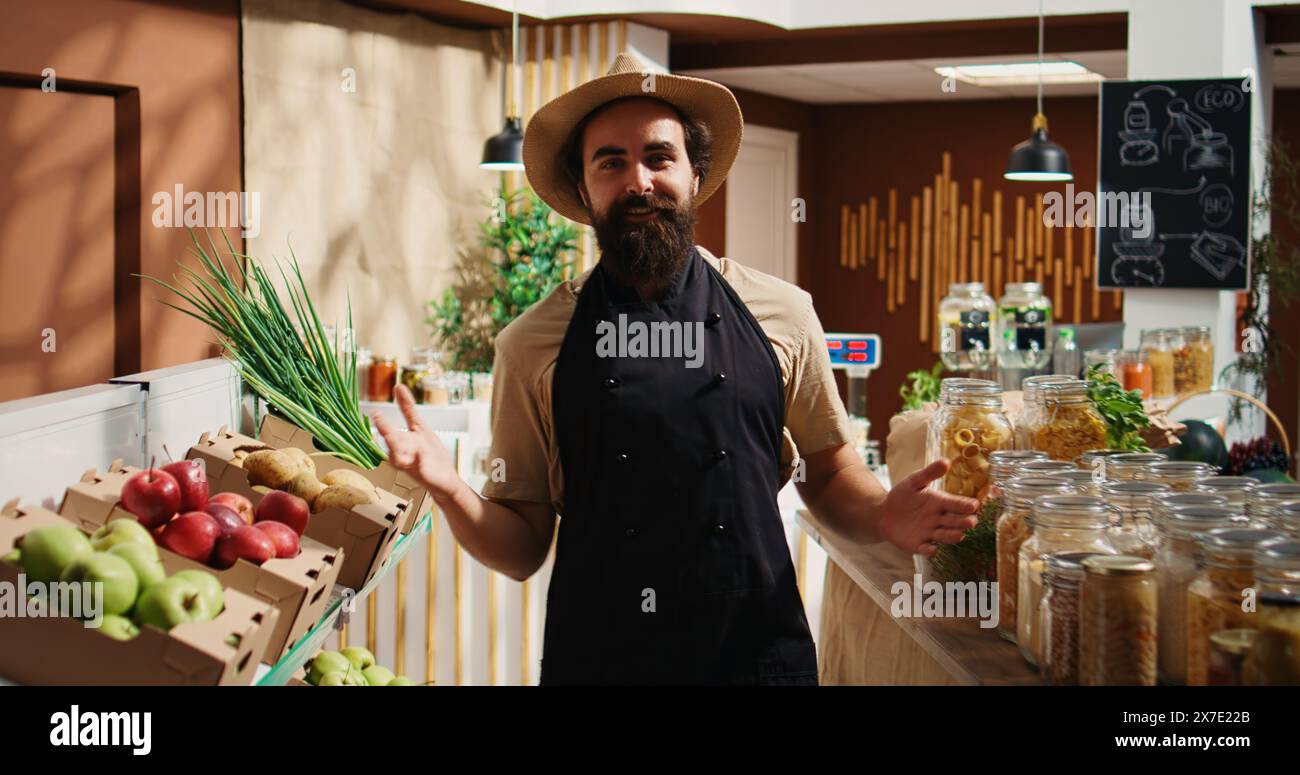 Owner greeting first clients during vegan bio zero waste supermarket ...