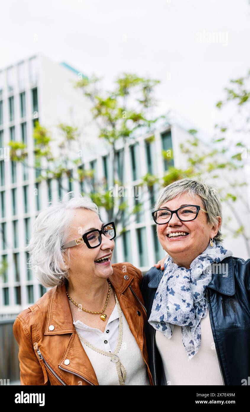 Two senior adult women having fun together at city street Stock Photo ...