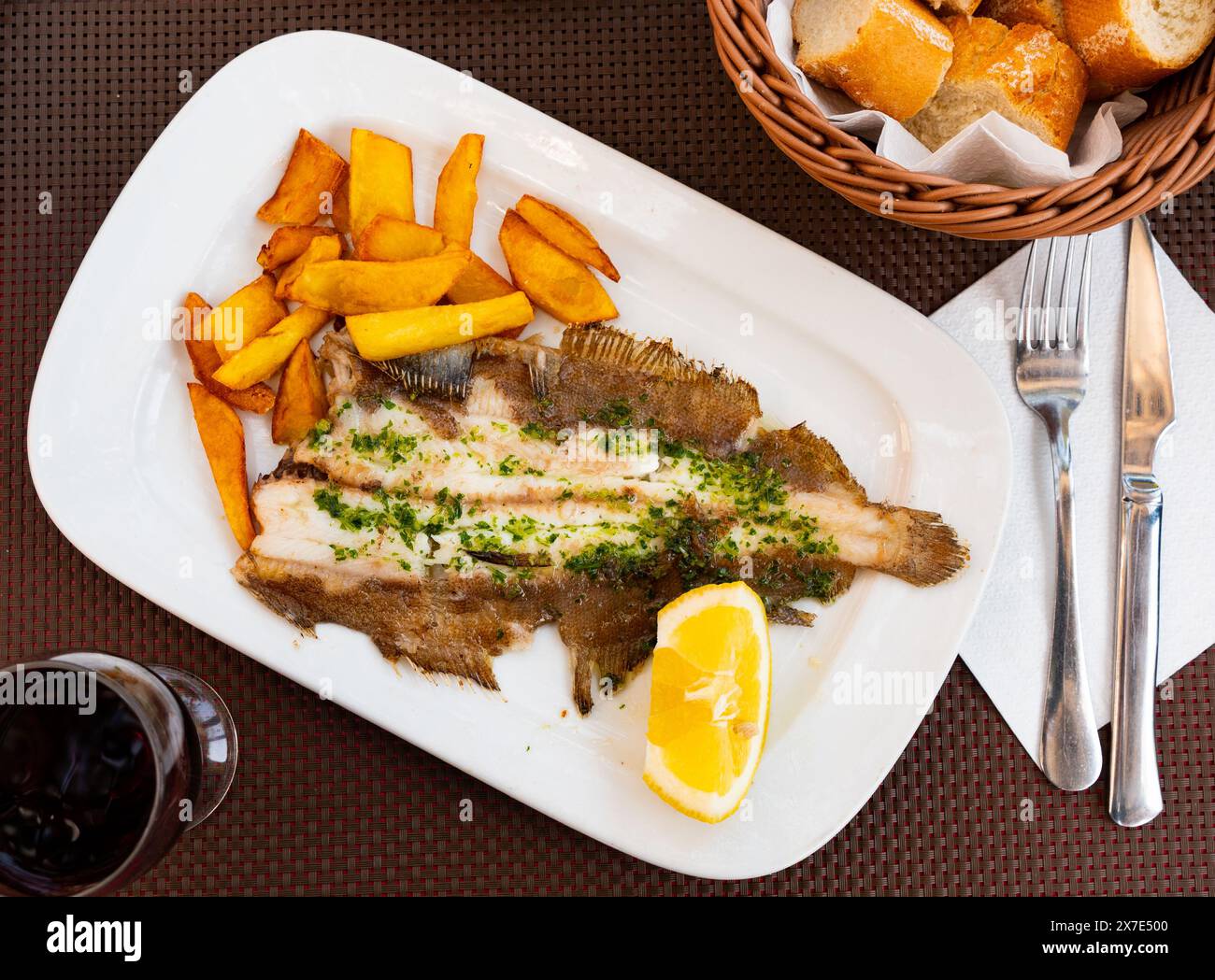 Grilled John Dory fillet with fried potato wedges and lemon Stock Photo ...