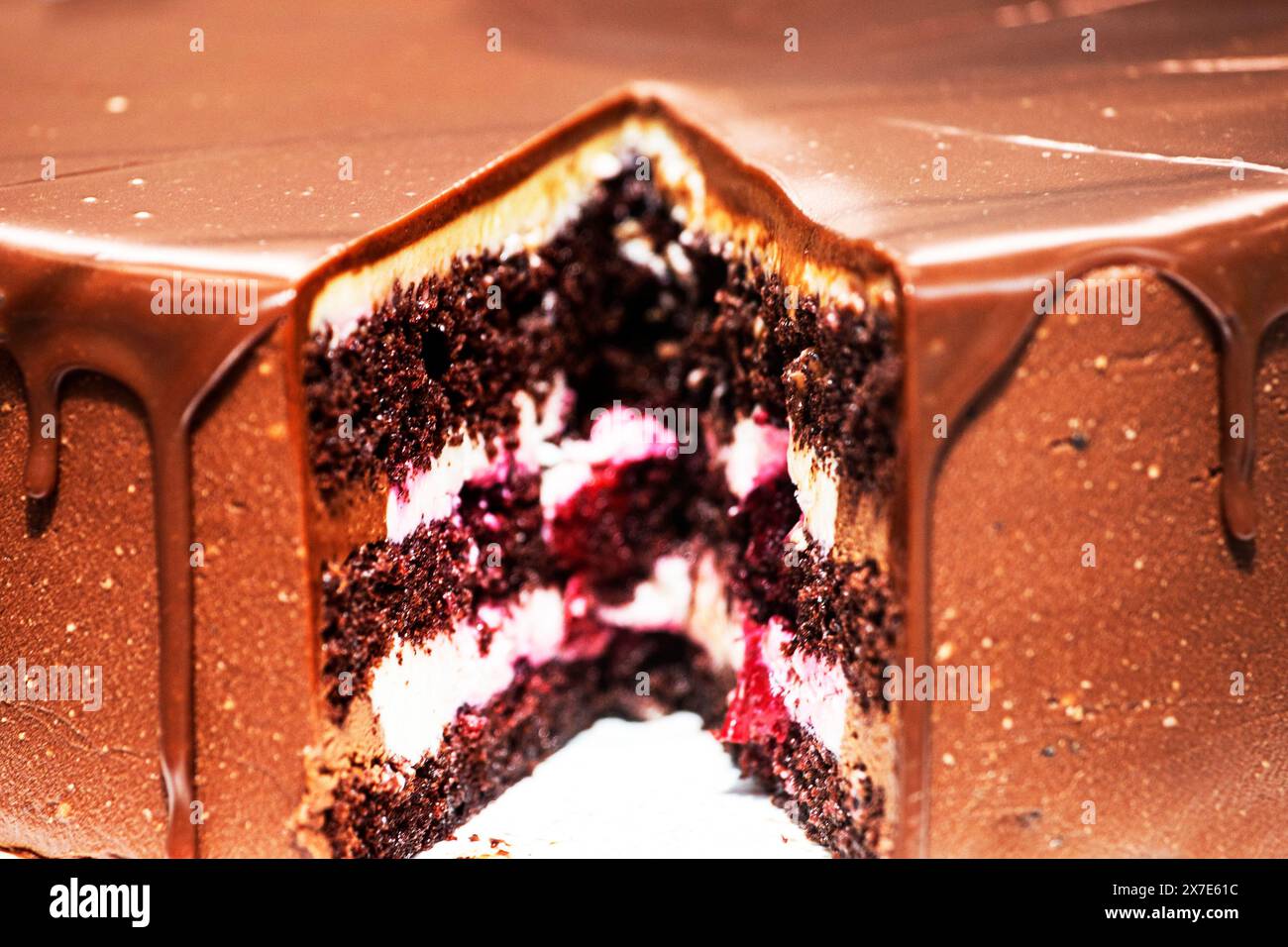 beautiful chocolate cake with sponge dough with a cut piece on display ...