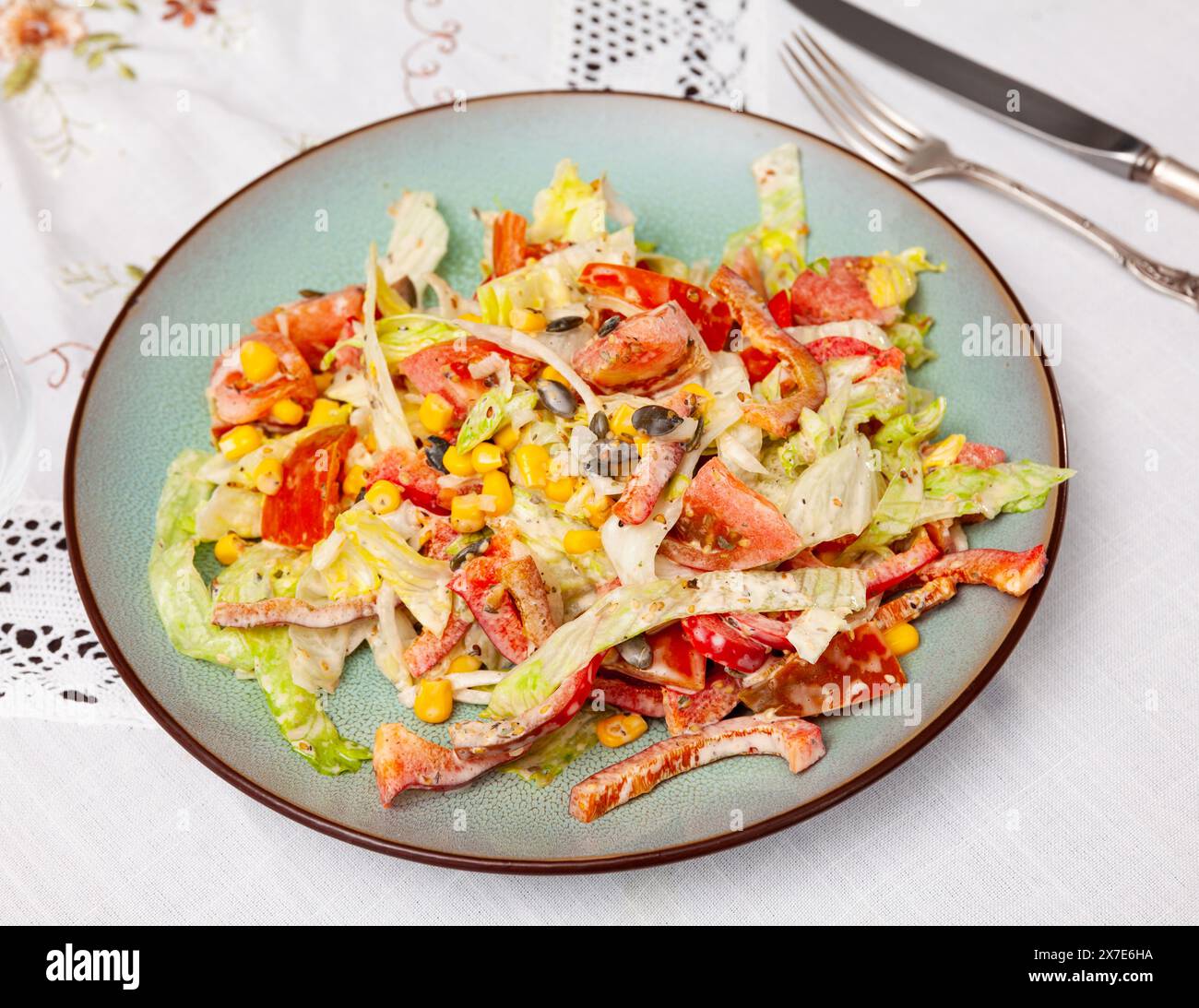 On plate, portion is laid out with pim salad of corn, cabbage ...