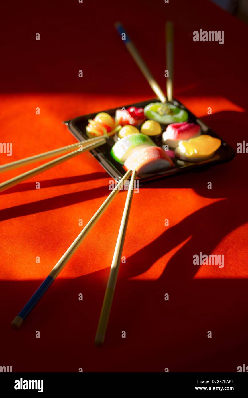 Jelly candies Sushi set in a black box on red background Contrast dark ...