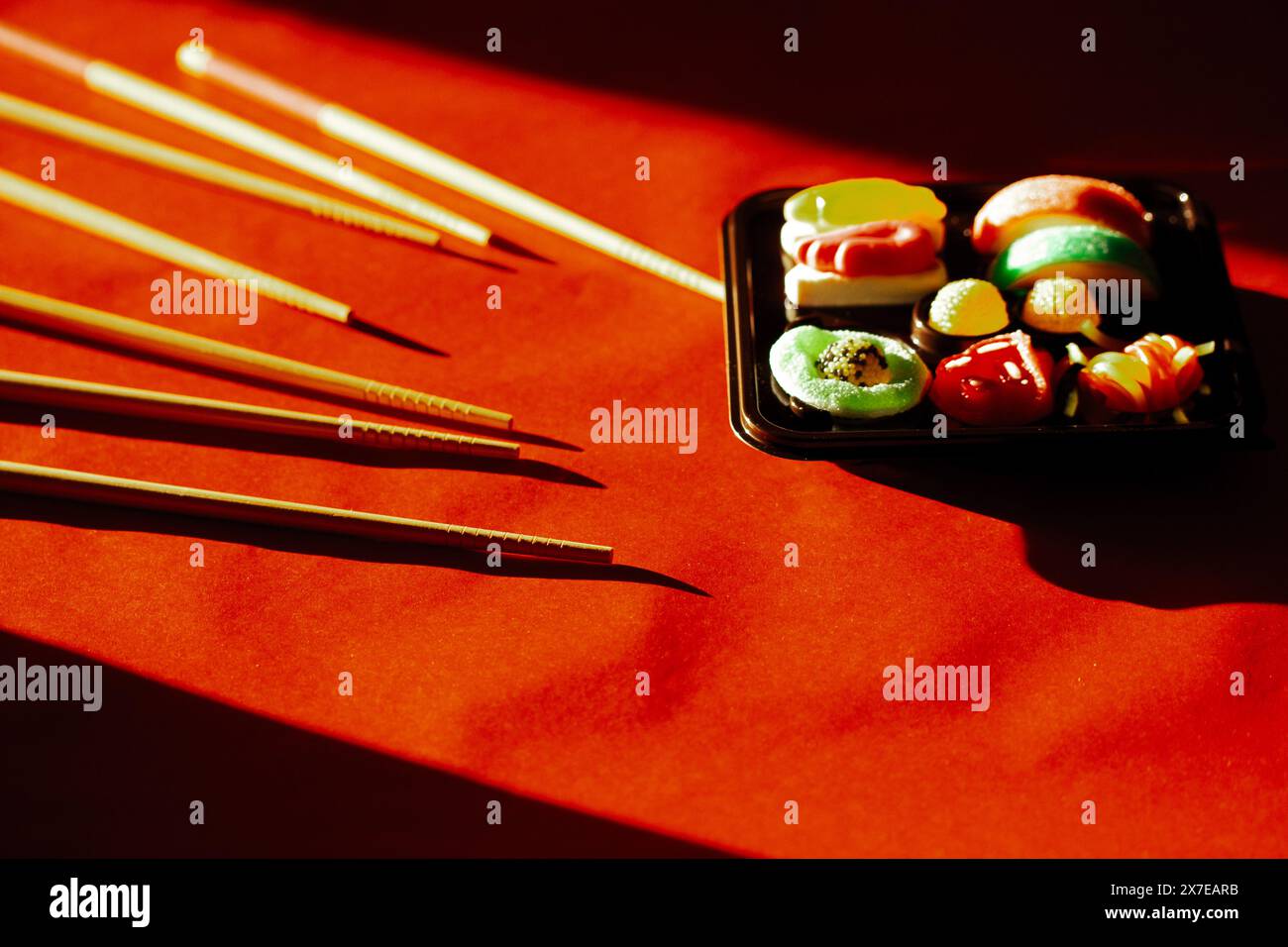 Jelly candies Sushi set in a black box on red background Contrast dark ...