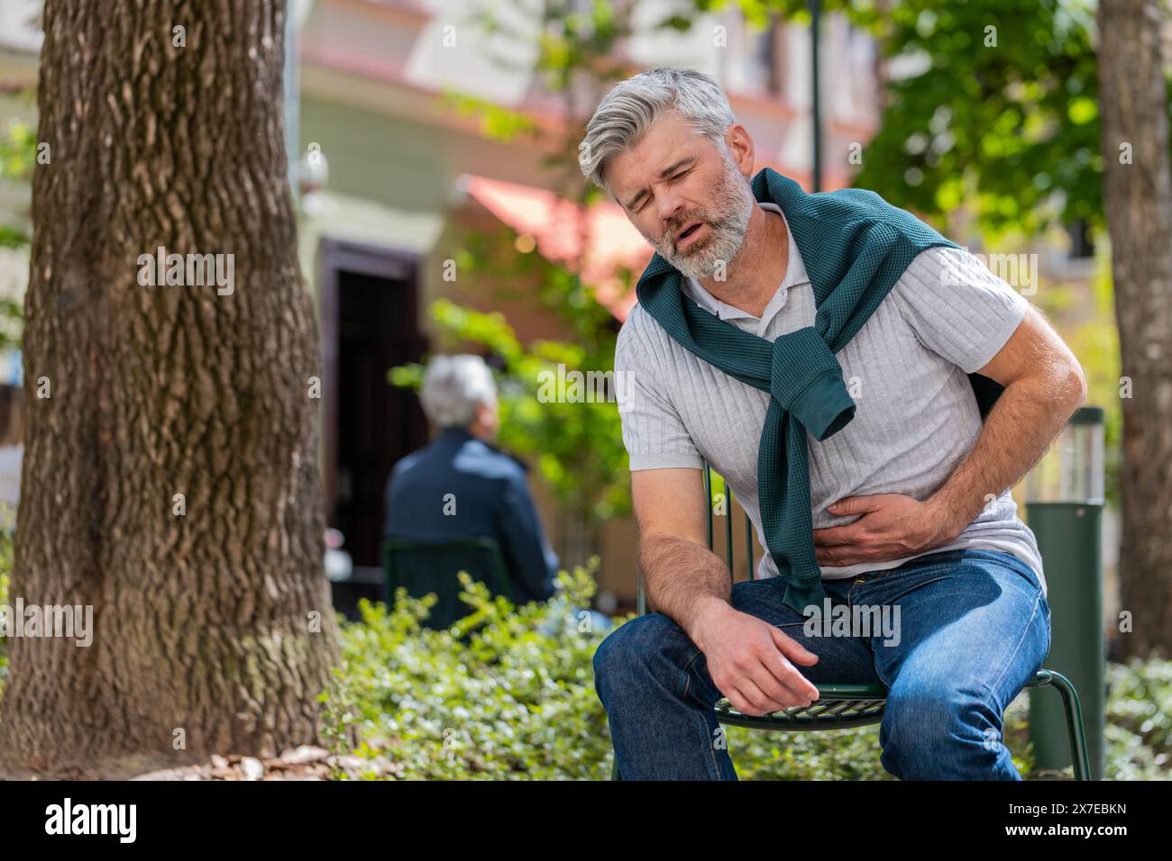 Caucasian mature man feeling sudden strong abdominal stomach ache ...