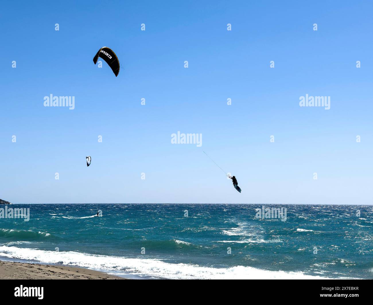 Kitesurfer Kitesurfer takes off in strong wind and waves rough sea ...