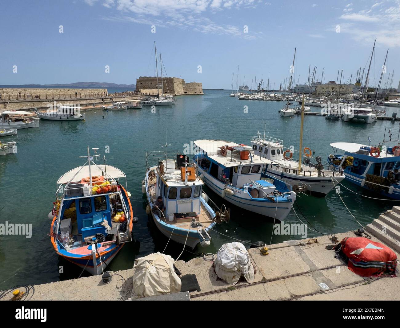 Several small fishing boats in historic Venetian harbour of Heraklion ...