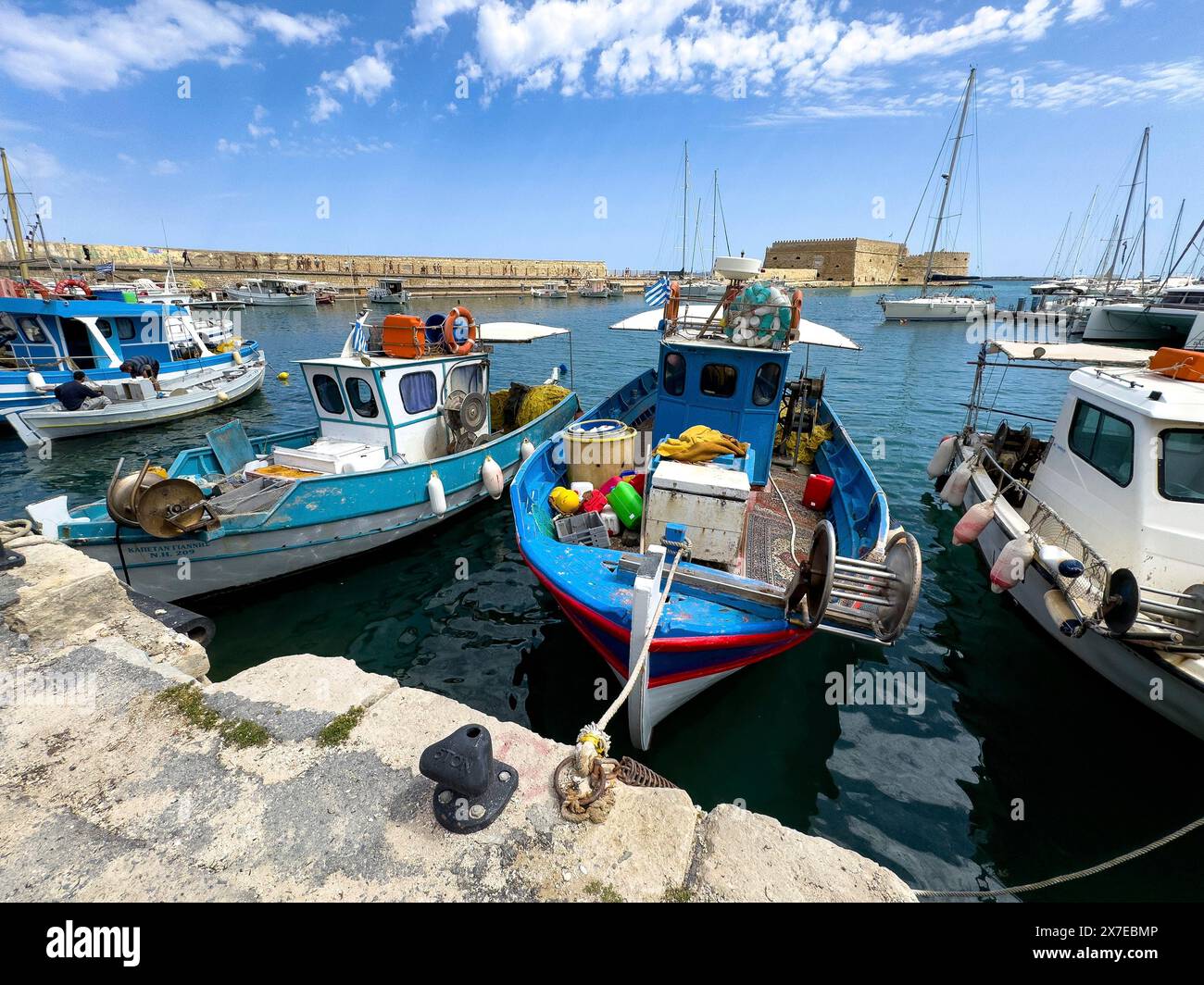 Several small fishing boats in historic Venetian harbour of Heraklion ...