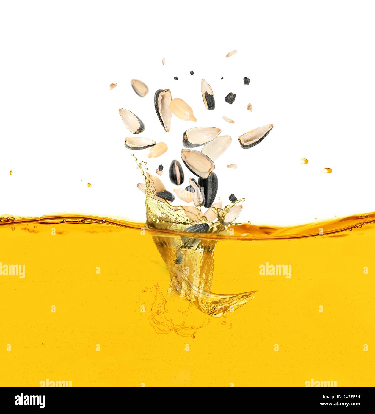 Sunflower seeds falling into cooking oil on white background Stock ...