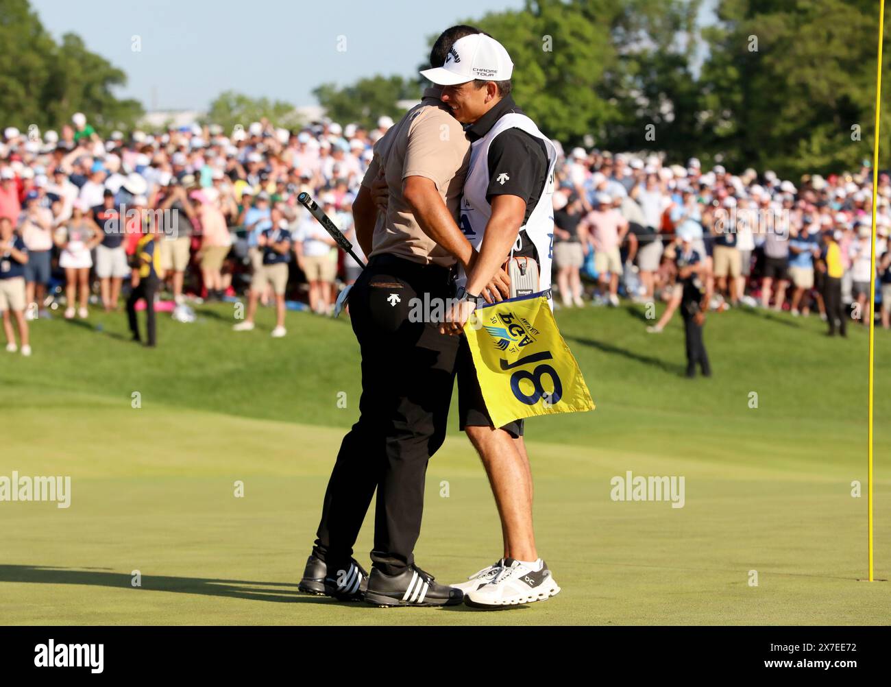 Xander Schauffele celebrates with his caddie after sinking a birdie ...