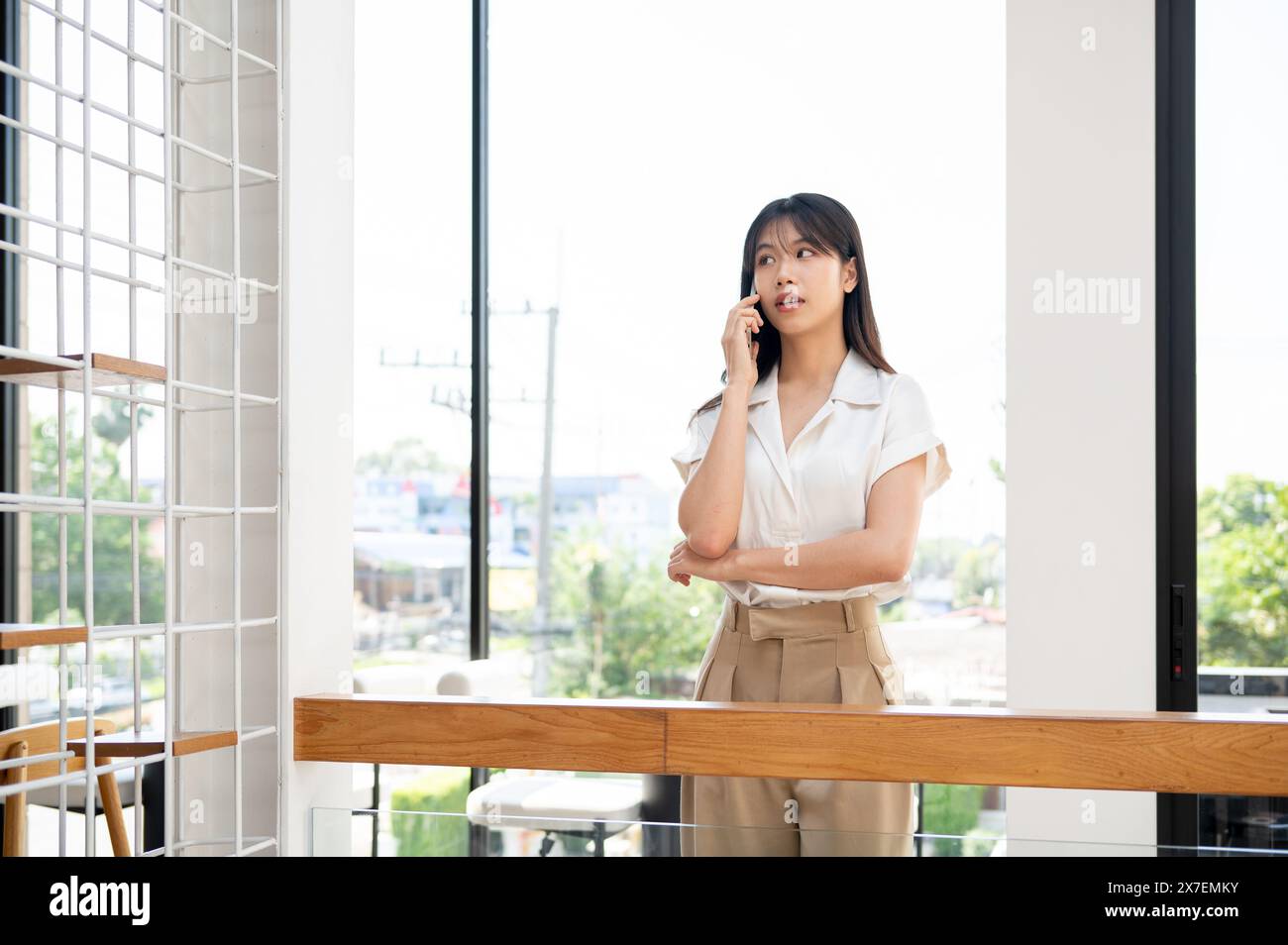 A confident, attractive millennial Asian businesswoman is having a ...