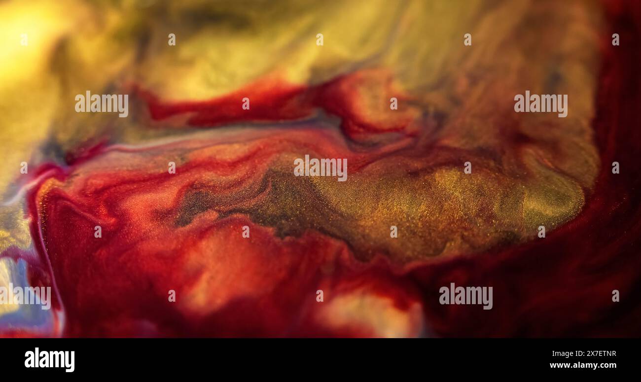 Glitter paint wave. Shiny liquid. Defocused red golden color metallic ...