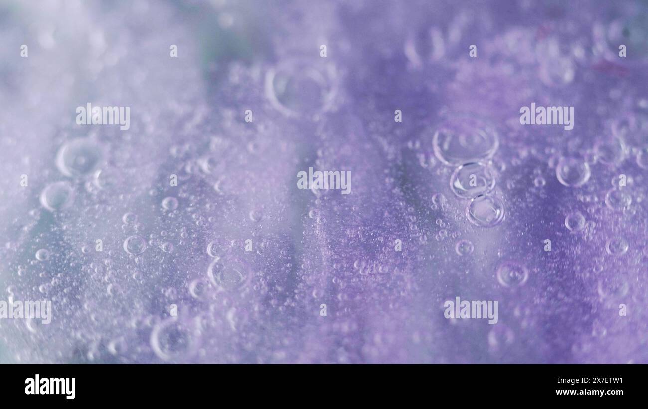Foam gel. Bubble texture. Defocused purple green color transparent oil ...