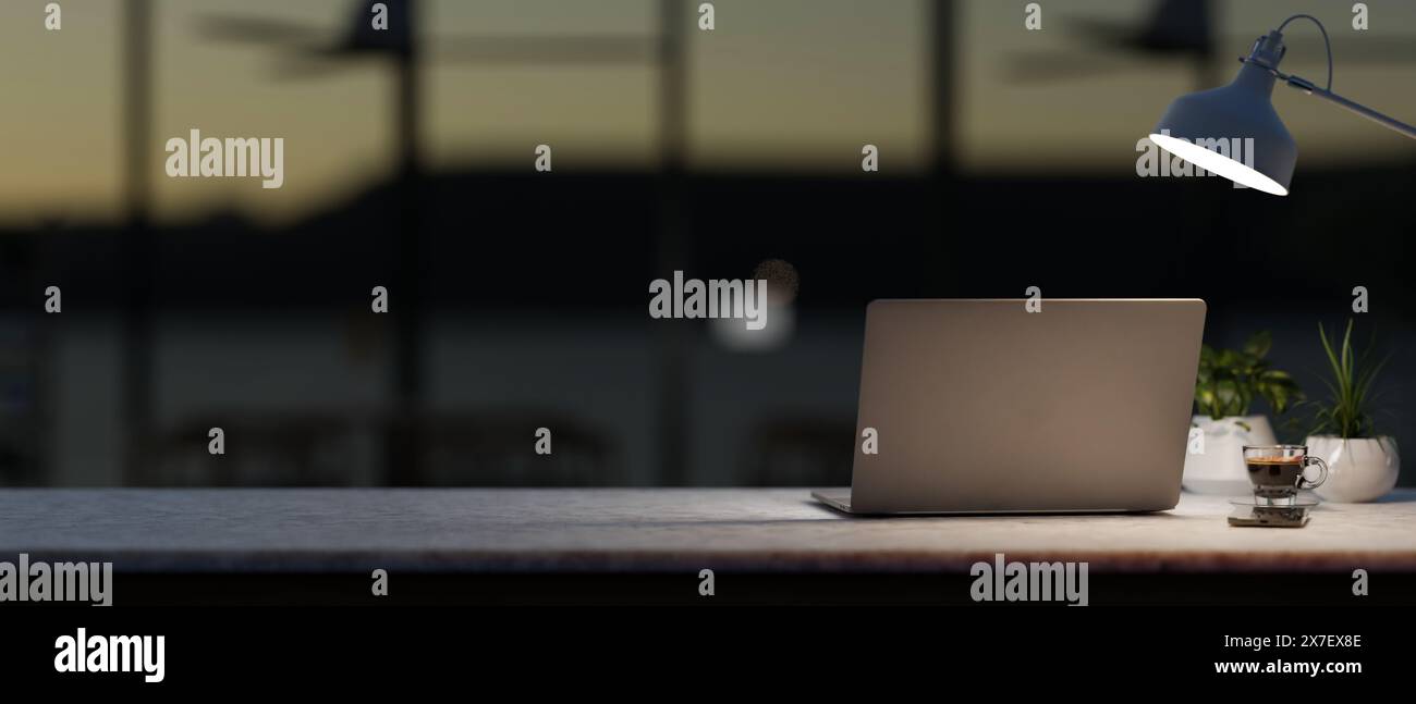 A modern, dark office workspace at night features a laptop computer, a ...