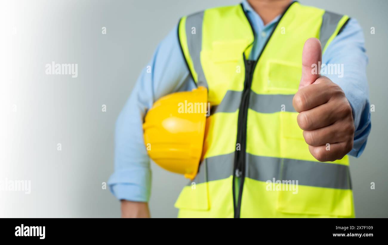 Civil engineer architect standing holding a safety helmet on grey ...