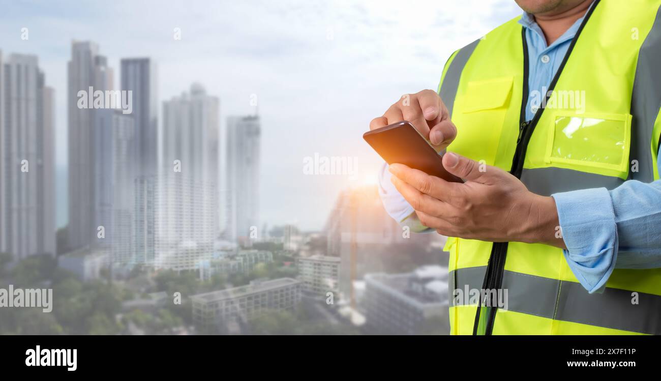 Civil engineer architect Using a smartphone to communicate and give ...