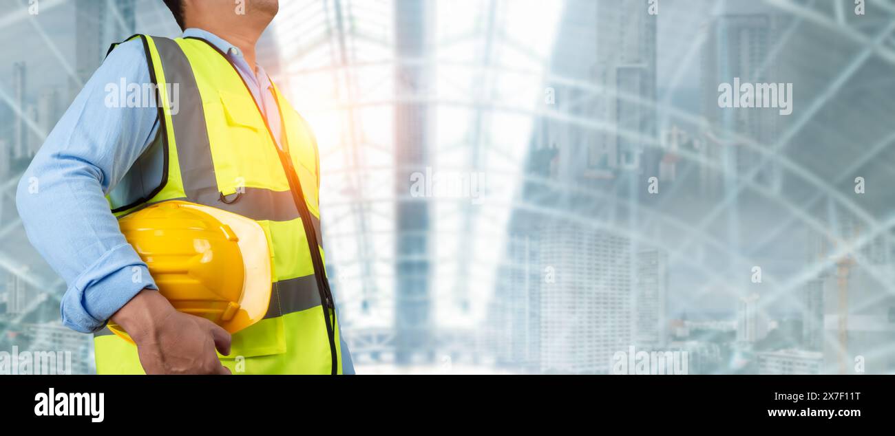 Civil engineer architect standing holding a safety helmet on ...