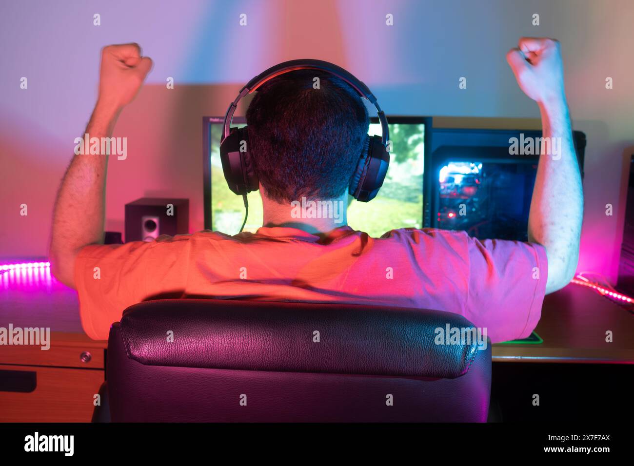 A gamer celebrating a big win with an enthusiastic pose Stock Photo - Alamy