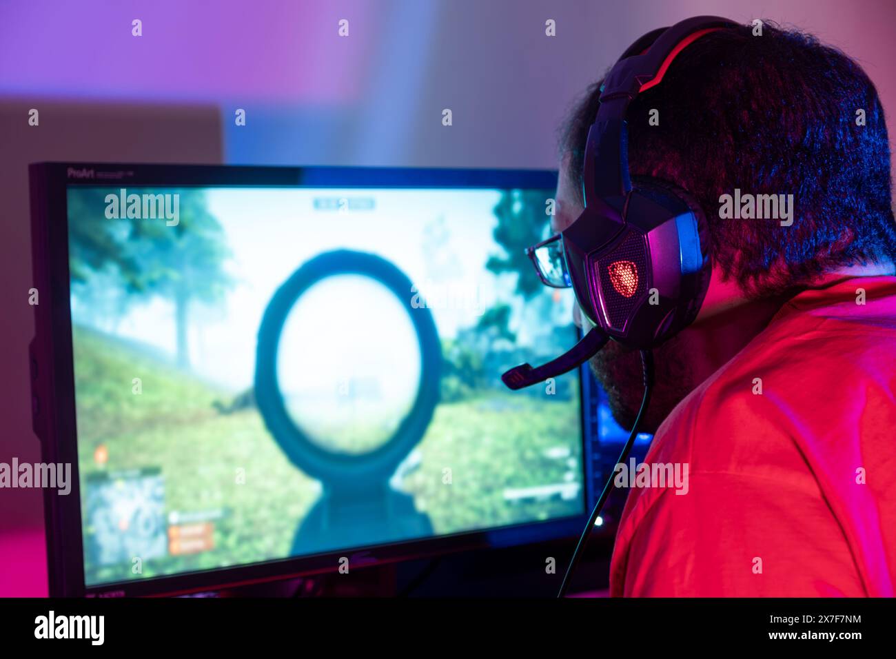 A gamer intensely engaged in gameplay, with a determined and focused ...