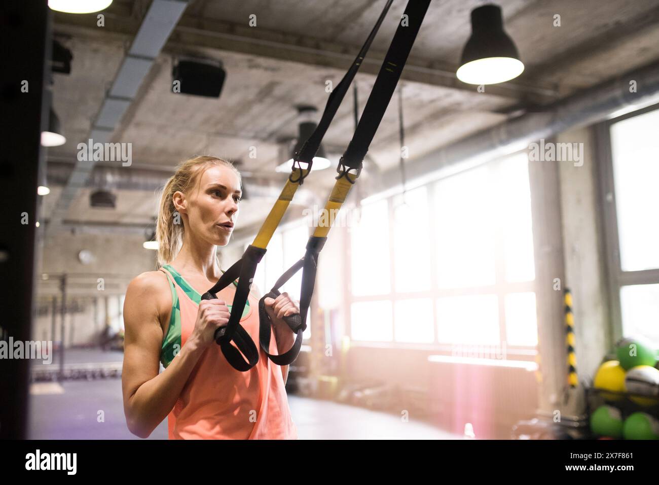 Beautiful sport woman doing suspension training, total resistance ...