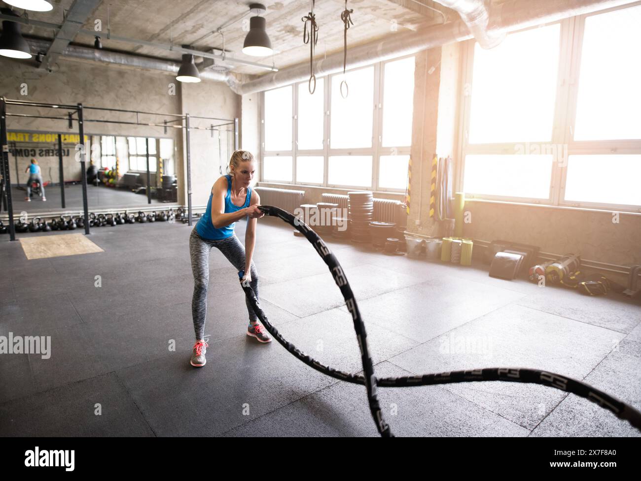 Woman doing battle rope hi-res stock photography and images - Alamy