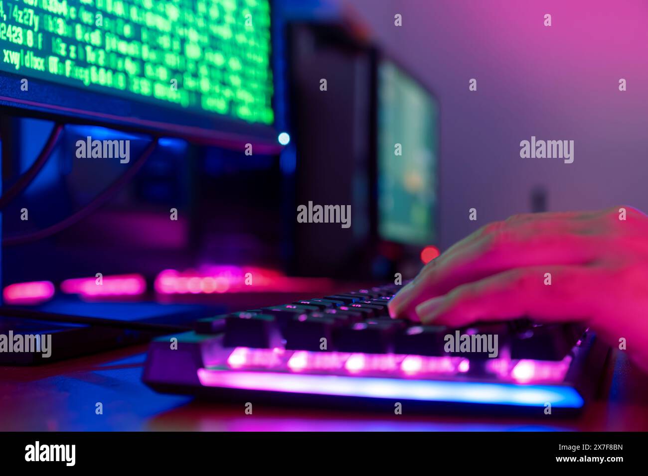 Professional online gamer hand fingers mechanical keyboard in neon ...