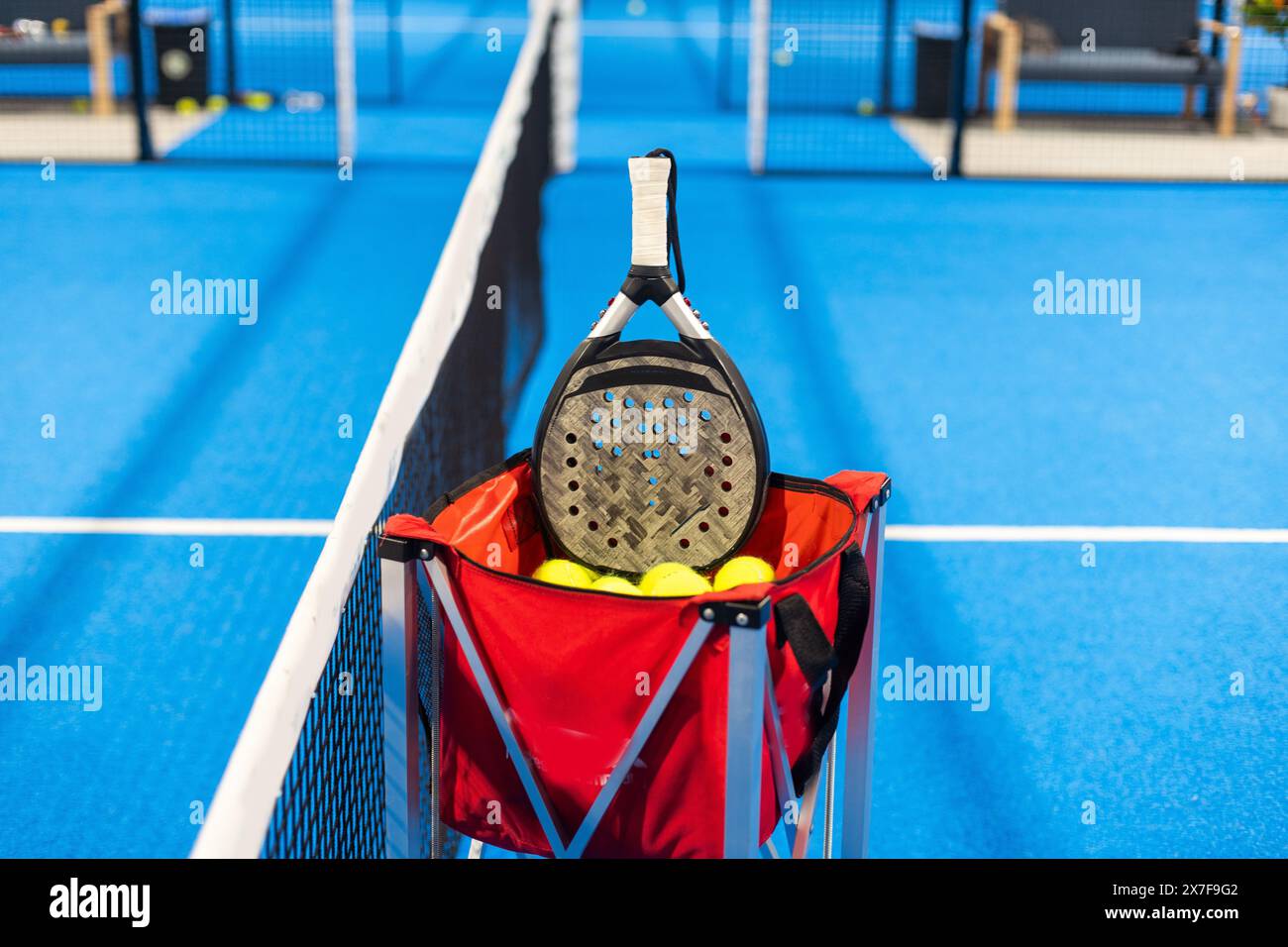 Paddle tennis: Padel racket and ball in front of an outdoor court Stock ...