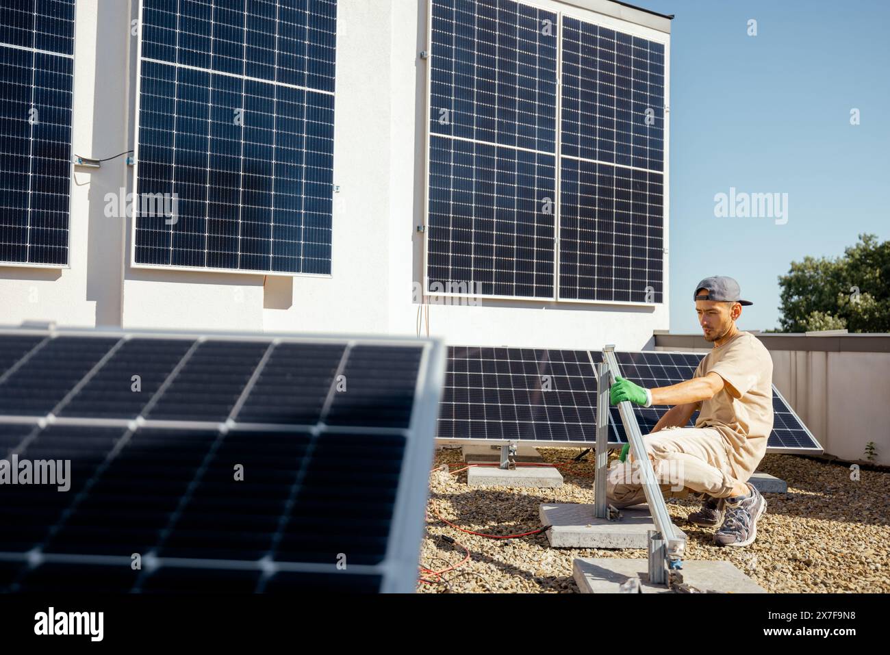 Man installing solar power plant on a house rooftop Stock Photo - Alamy