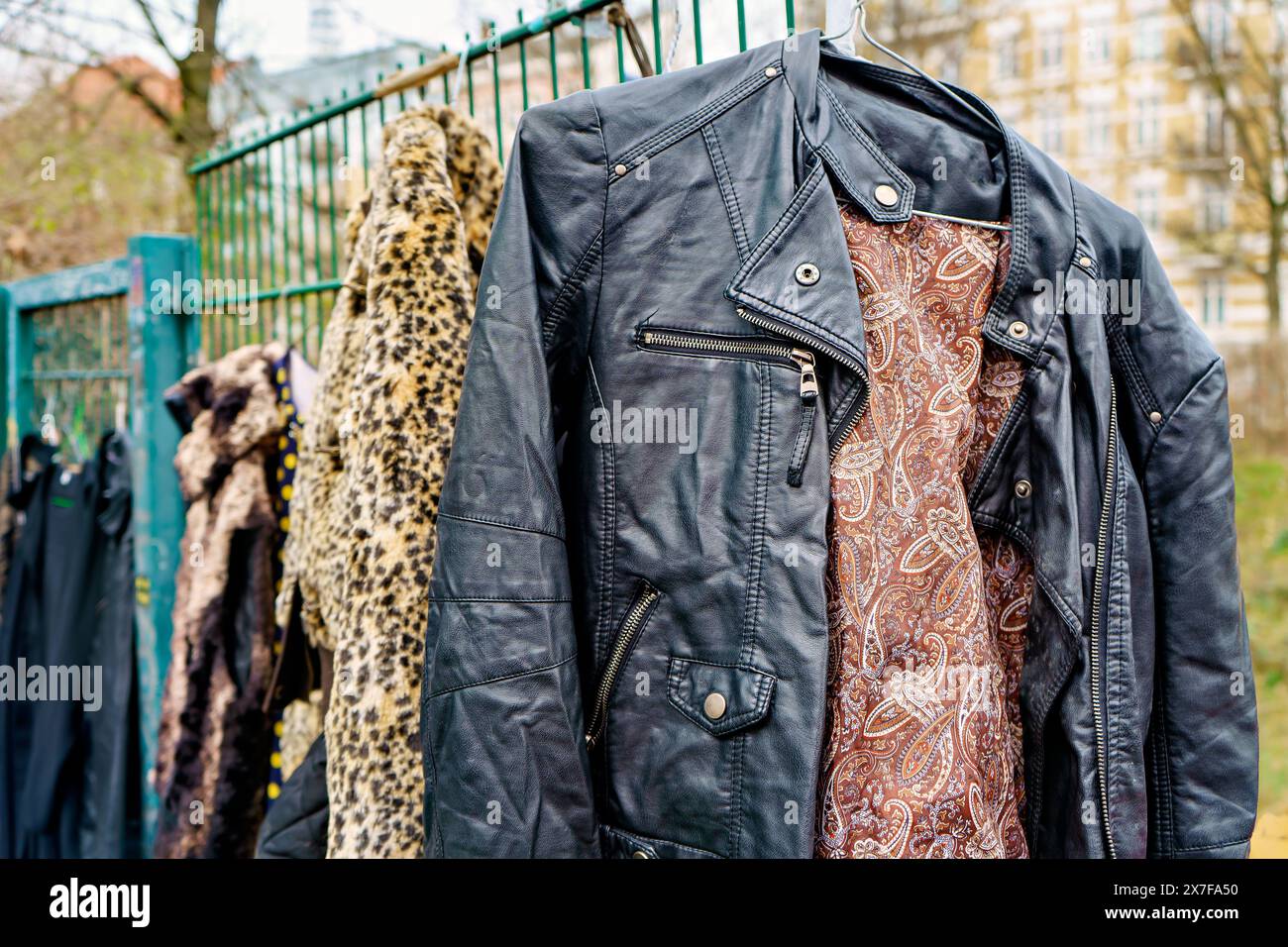 Vintage Jackets on a Fence: Leather and Leopard Print Coats Hanging ...