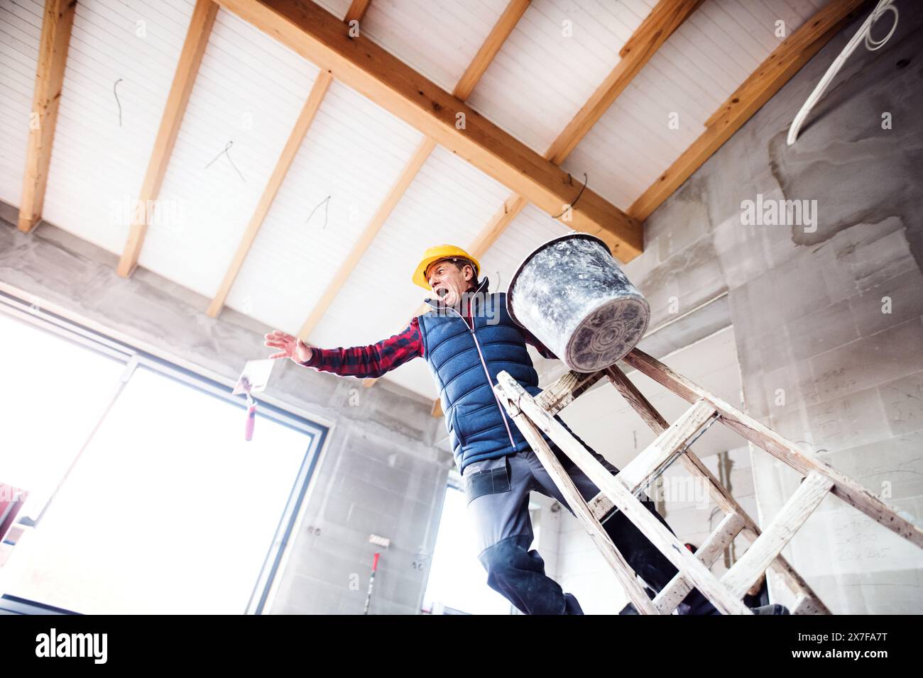 Man falling off the ladder. Accident of a man worker at the ...