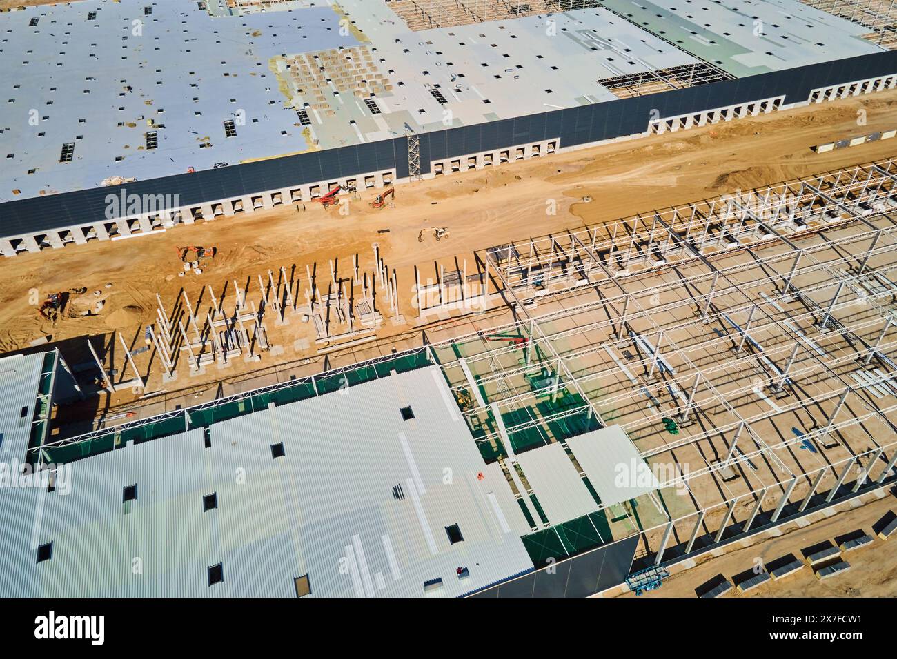 Aerial view of construction site with warehouse building under ...