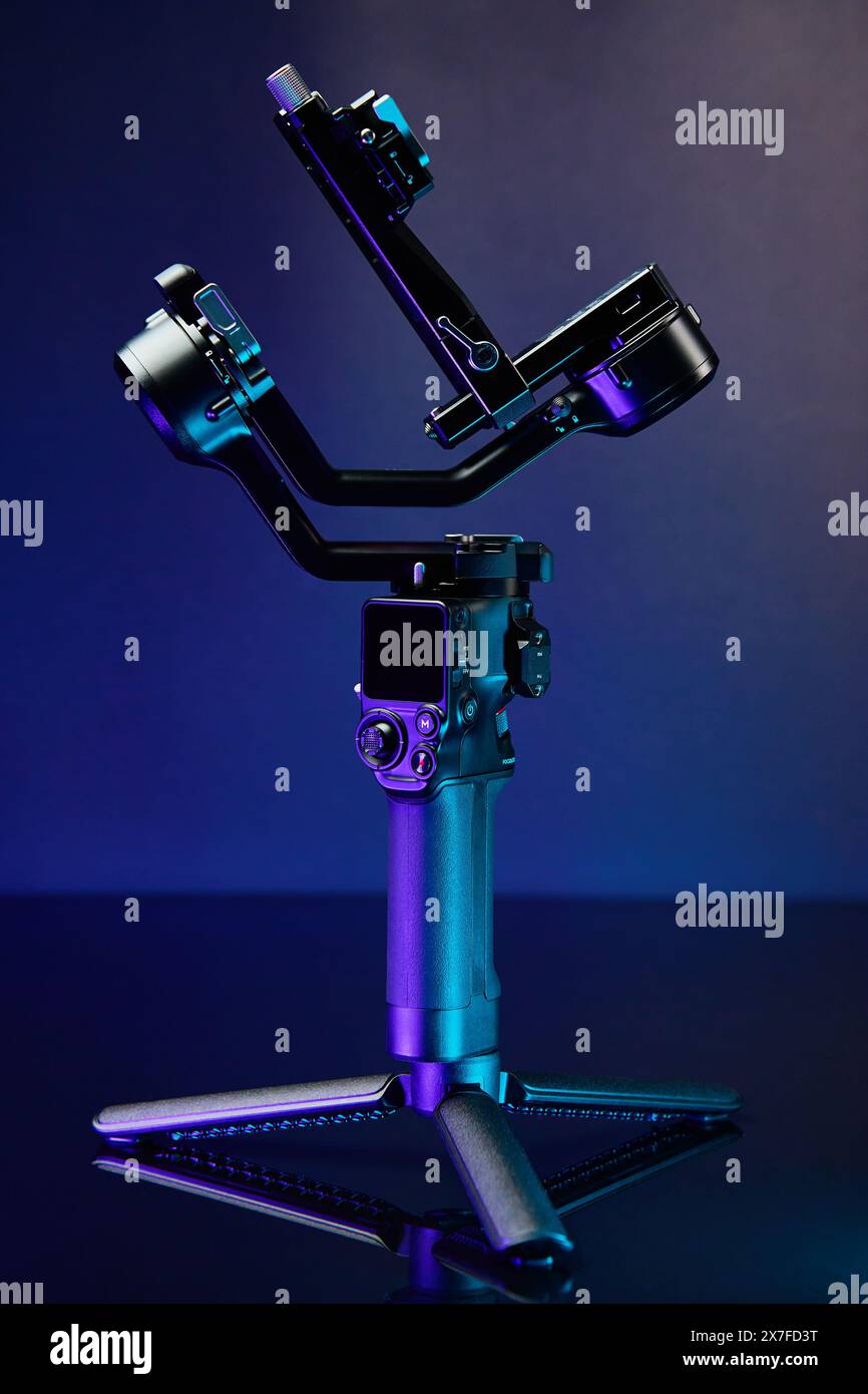 Gimbal on dark background with neon light. Camera stabilization ...