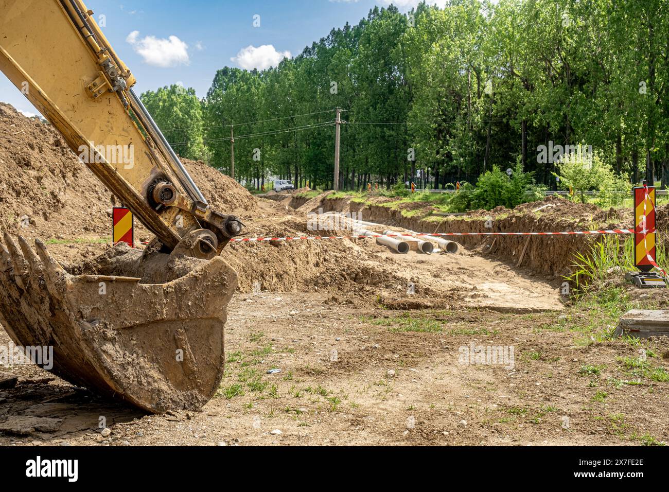 an excavator bucket near construction site, New fiber glass water ...