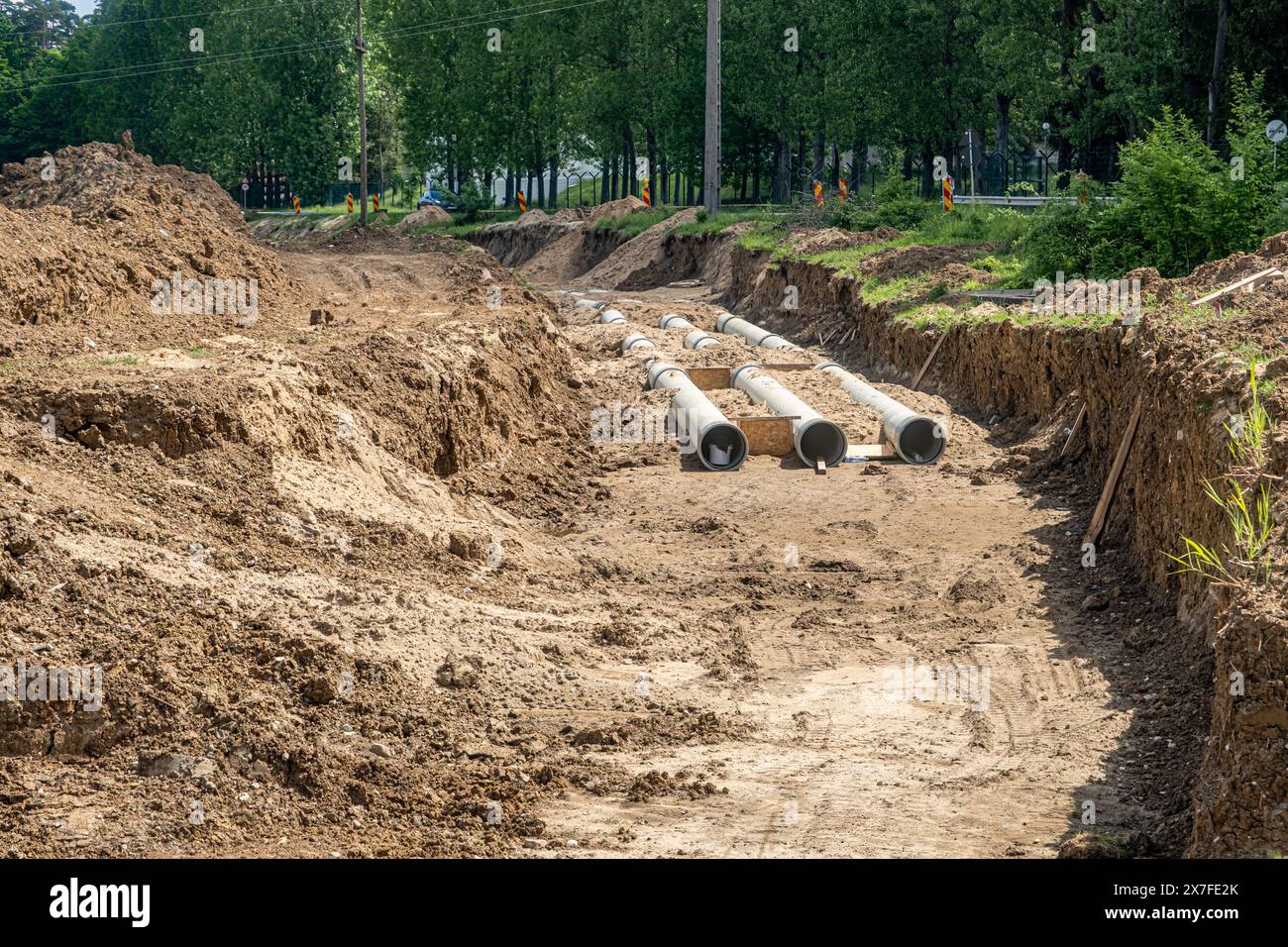 New fiber glass water pipeline in trench. Replacement of old rusty ...